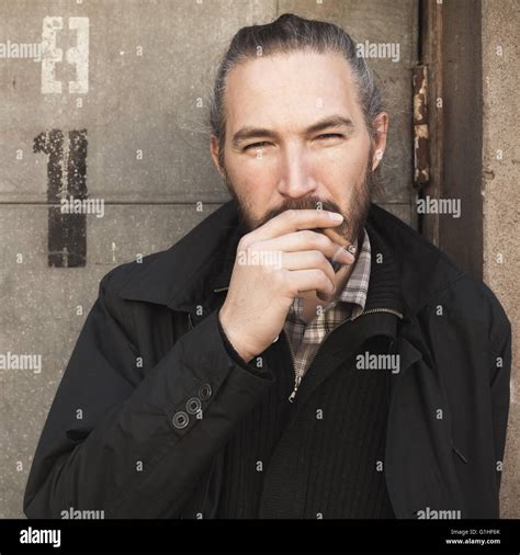 Bearded Man Smoking Cigar Outdoor Square Portrait With Selective Focus