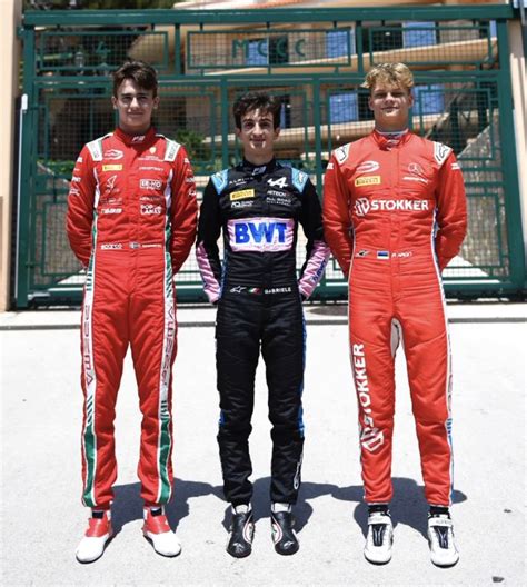Three Men Standing Next To Each Other In Front Of A Building