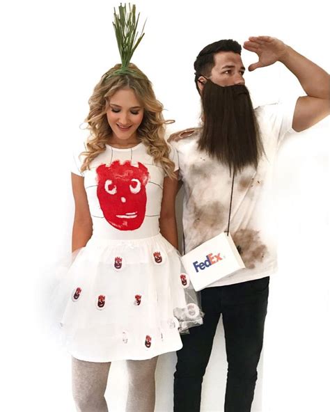 Two People Dressed In Costumes Standing Next To Each Other