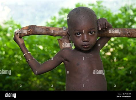 Shirtless African Boy Leans Against Wood Railing Stock Photo 17022715