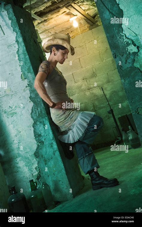 Woman Leaning Up Against Wall In Basement Stock Photo Alamy