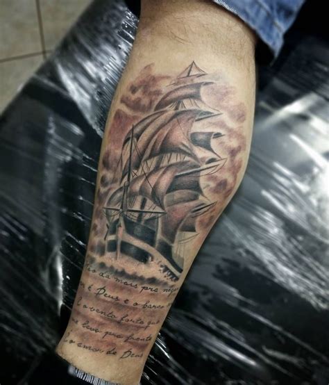 A Man S Arm With A Ship Tattoo On It And Some Words Written In Ink