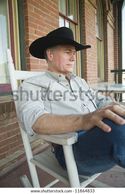 Man Wearing Cowboy Hat Sitting On Stock Photo Edit Now 11864833