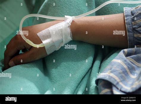 Female Patient With Iv On Hand In The Hospital An Asian Female Patient