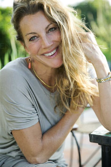 Portrait Of Beautiful Mature Woman With Long Blond Hair Stock Photo