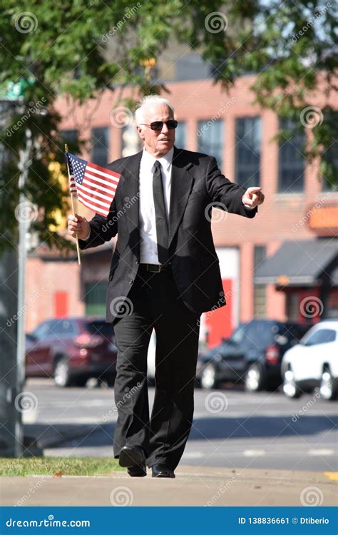 Serious Male Politician Wearing Suit And Tie Walking On Sidewalk Stock