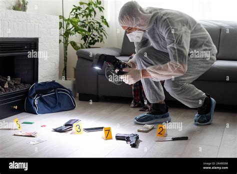 Detective Collecting Evidence In A Crime Scene Forensic Specialists