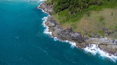 Aerial View Of Sea Waves Crashing On Rocks Cliff In The Blue Ocean Top
