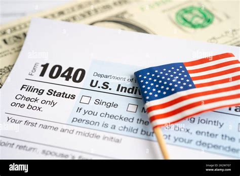 Tax Return Form 1040 With USA America Flag And Dollar Banknote U S