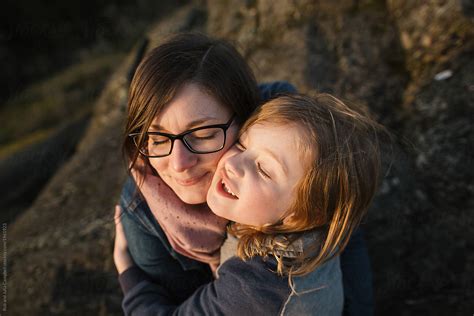 Smiling Mom And Son Pressing Faces Together In A Hug By Stocksy