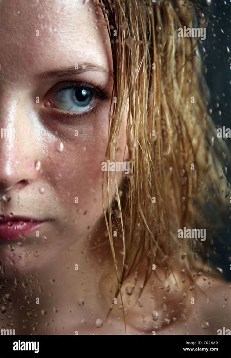 The Beautiful Girl Behind Wet Glass Stock Photo Alamy