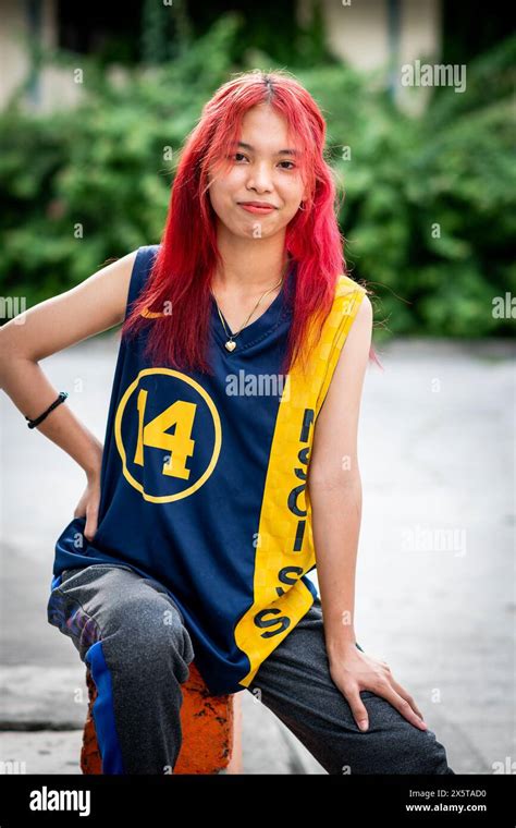 A Beautiful Young Filipino Girl With Red Hair Poses Outside Her Home In Angeles City The