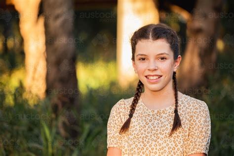 Image Of Portrait Of Happy Pre Teen Girl Wearing Dress In Australian Country Bush Setting