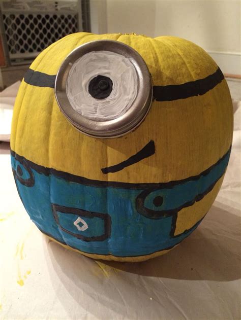 A Yellow And Blue Decorated Pumpkin Sitting On Top Of A Table