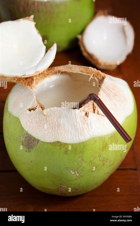 Green Coconut Water Drink With Straw On Wooden Table Stock Photo Alamy