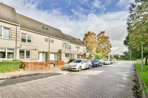 A Row Of Houses With Cars Parked On A Street Editorial Stock Image