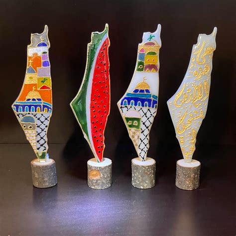 Four Colorful Vases Sitting On Top Of Each Other