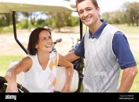 Proud That My Wife Plays Golf Smiling Woman Seated In A Golf Cart With Her Husband Standing