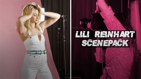 A Woman In White Pants Standing Next To A Pink Wall With The Words Lil