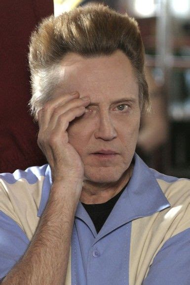 A Man Sitting Down With His Hand On His Face