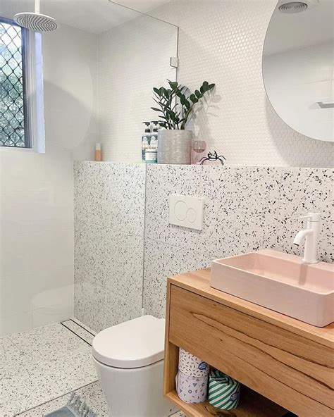 A Bathroom With A Sink Toilet And Shower Stall In The Background Is An