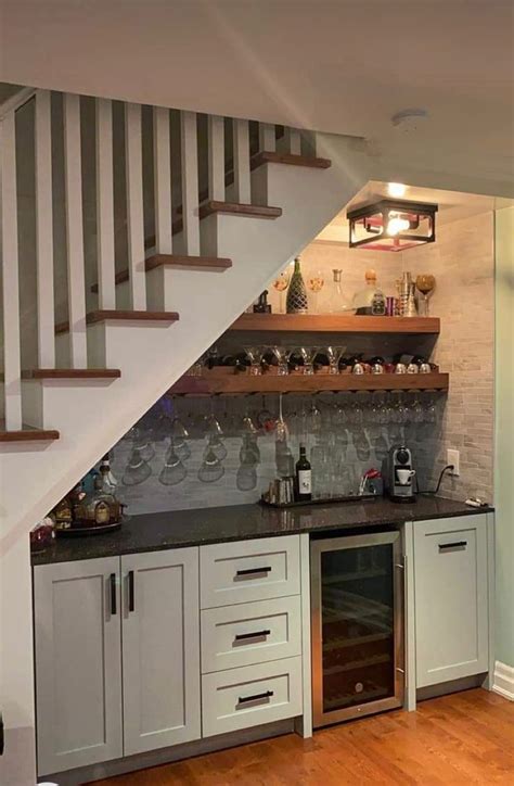A Kitchen With An Oven Sink And Shelves Under The Stairs In Front Of It