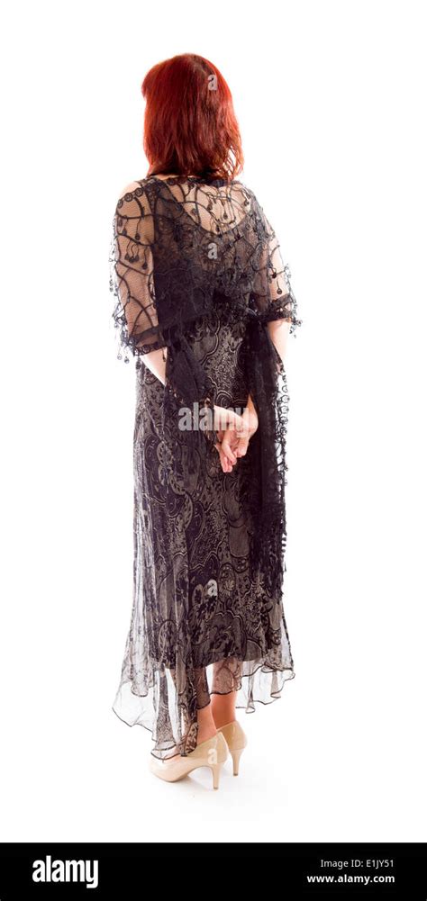 Rear View Of A Mature Woman Thinking With Her Hands Behind Back Stock
