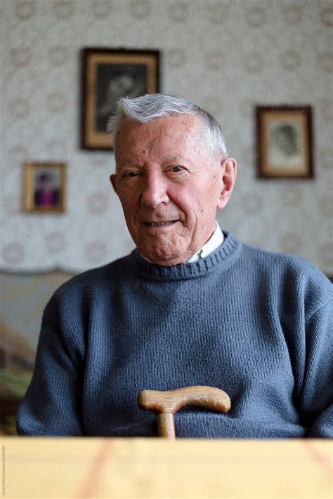 Portrait Of A Senior Man Sitting In The Living Room Del Colaborador
