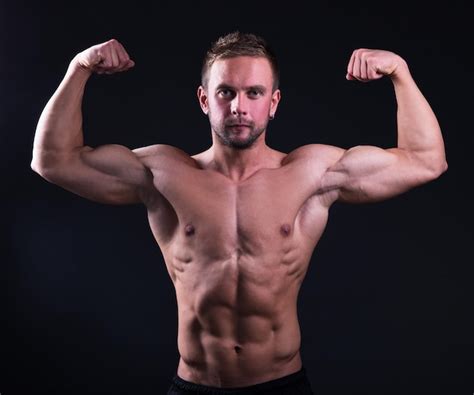 Premium Photo Portrait Of Handsome Muscular Man Showing His Muscles
