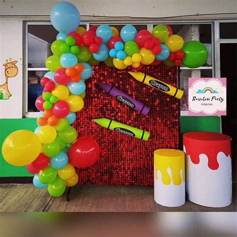 An Arch Made Out Of Balloons And Crayons