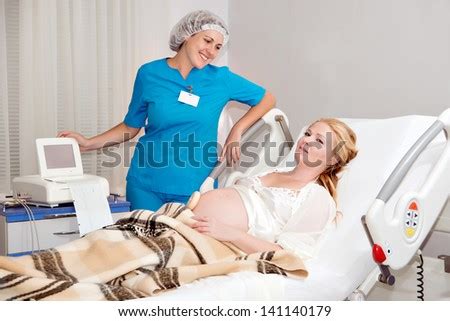 Screening Of Pregnant Women In The Hospital Doctor Examines A Pregnant