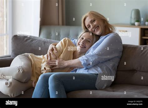 Happy Mature Mom Cuddling Grown Up Daughter Express Love Stock Photo