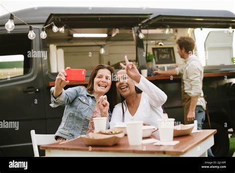 Adult Women Taking Selfie Near Food Truck Stock Photo Alamy