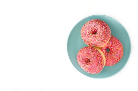 Premium Photo Pink Frosted Donut With Colorful Sprinkles Isolated On