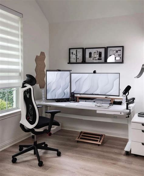 A Computer Desk With Two Monitors And A Keyboard On It In Front Of A Window