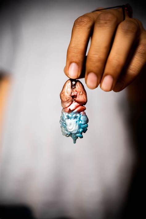A Person Holding A Small Toy In Their Hand