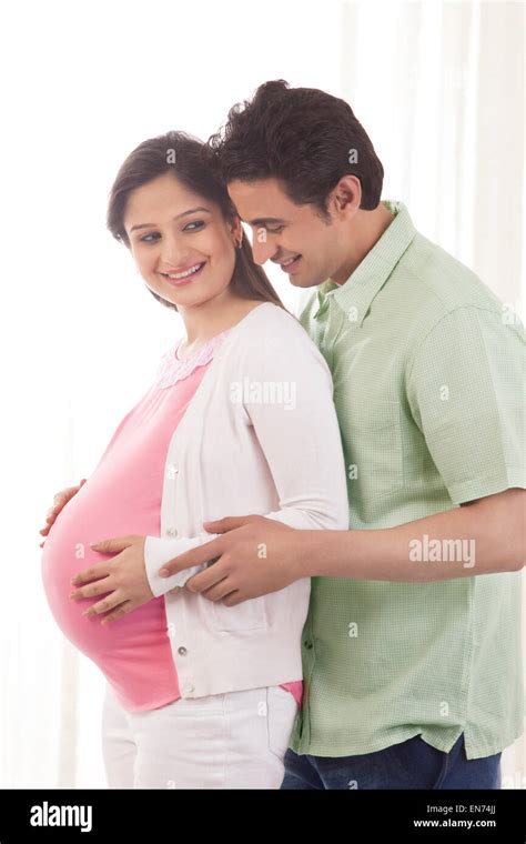 Man Embracing Pregnant Woman Stock Photo Alamy