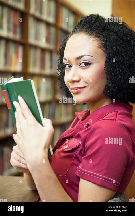 African Woman Reading Book In Library Stock Photo Alamy