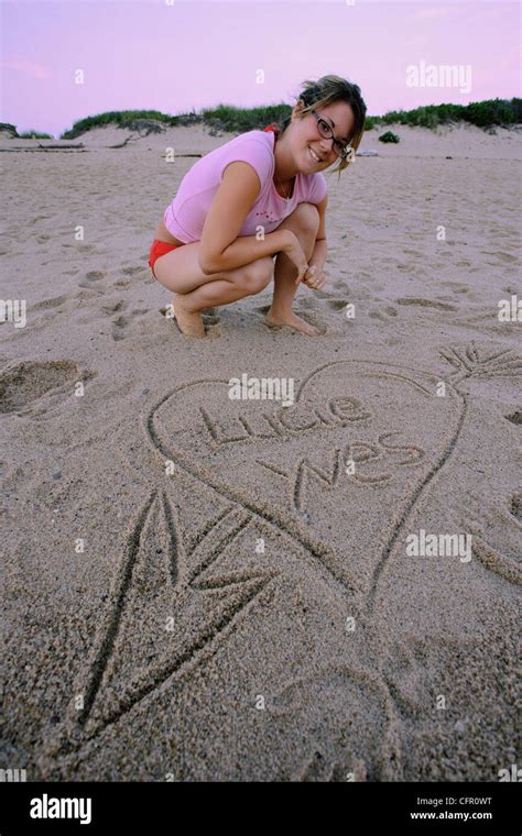 Teenager On Beach With Heart Drawing In Sand Stock Photo Alamy