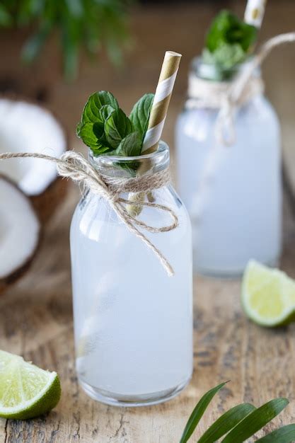 Premium Photo Two Bottles Of Coconut Water On A Wooden Table