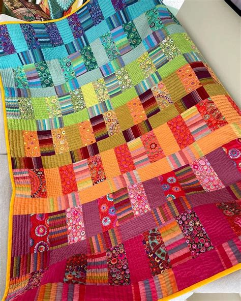 A Multicolored Patchwork Quilt On A Table