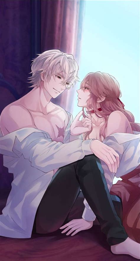 Two People Sitting Next To Each Other On A Bed