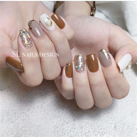 Two Hands With Different Manies On Them And One Is Holding Something In