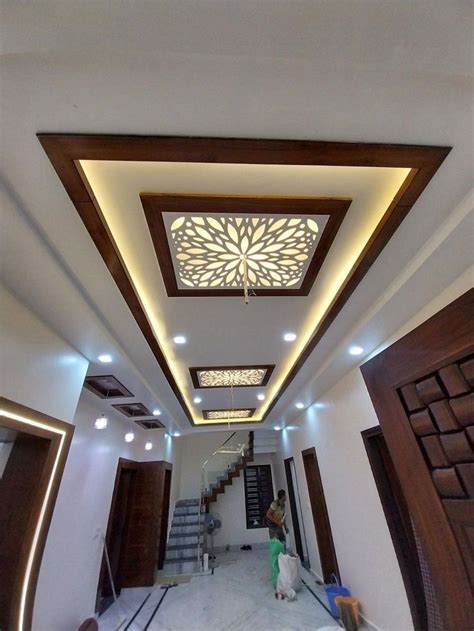 The Inside Of A House With Some Lights On And Wood Trimming Around The