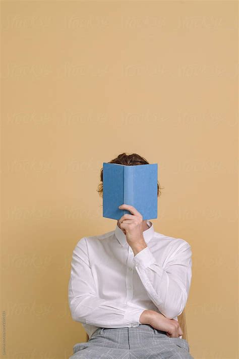 A Person Sitting Down With A Book Over Their Head By Jodi Lenski For