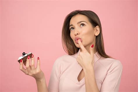 Woman Eating Cupcake Standing Pink Background Inside Room Piqsels