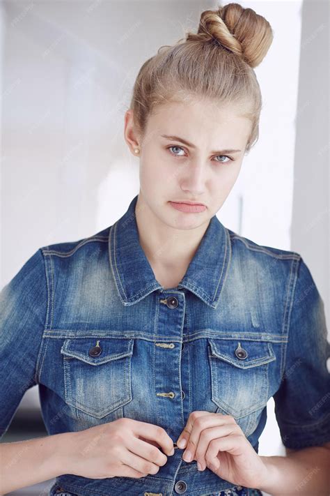 Free Photo Portrait Of A Blue Eyed Blond Female Dressed In A Denim Jacket