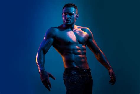 Premium Photo Sexy Man With Muscular Body And Bare Torso Blue Neon Light