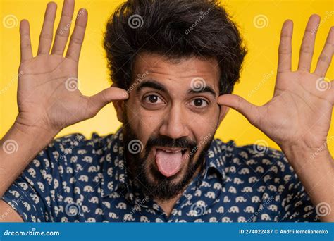 Cheerful Funny Bully Indian Man Showing Tongue Making Silly Faces Fooling Around Joking