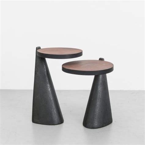 Two Black And Brown Tables Sitting On Top Of A White Floor Next To Each